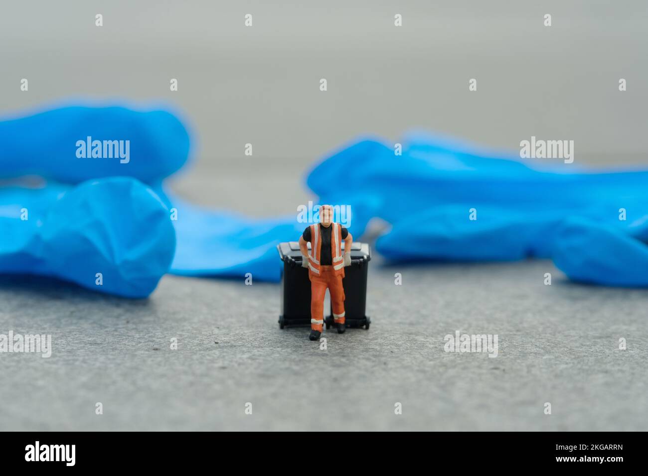 Miniature people toy figure photography. Cleaning worker with trash bin ...