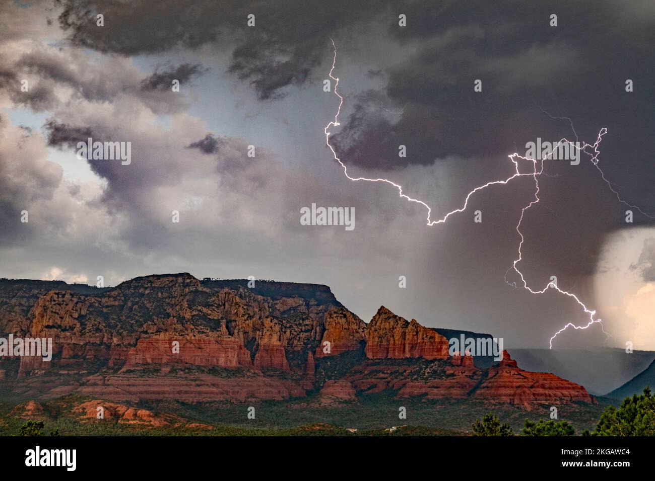 Intense lightning strike from a monsoon thunderstorm over the red rock ...
