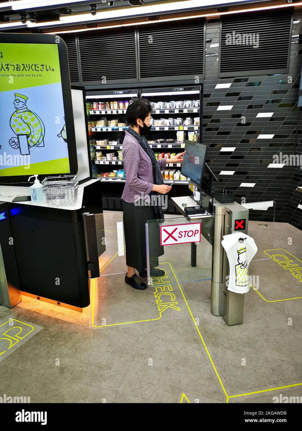 Editorial use only Woman paying for goods at a cashierless checkout in ...