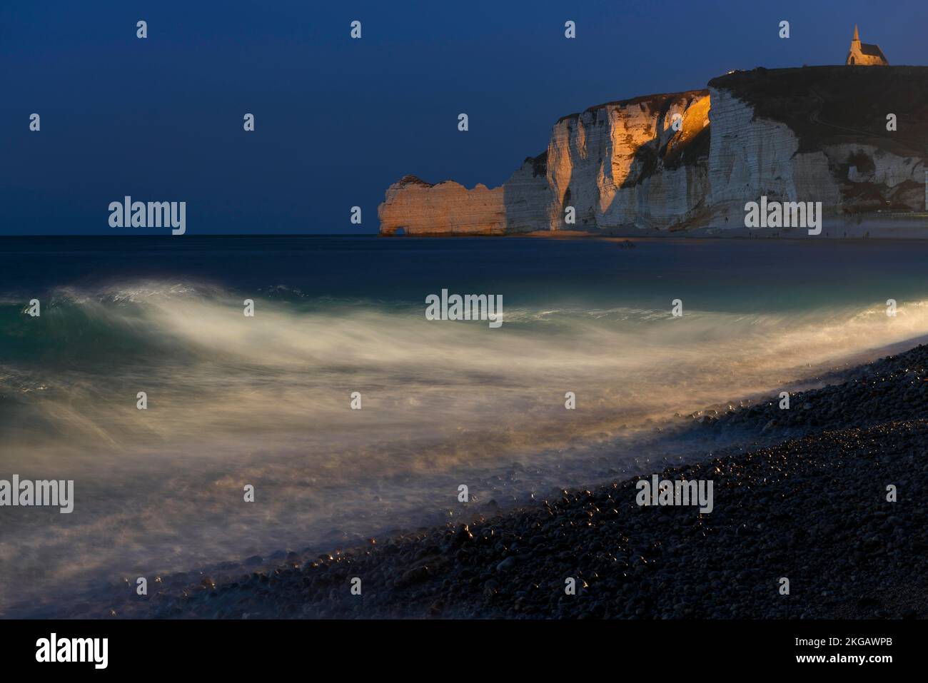 Étretat beach with view of Falaise d'Amont and Chapelle Notre-Dame de ...