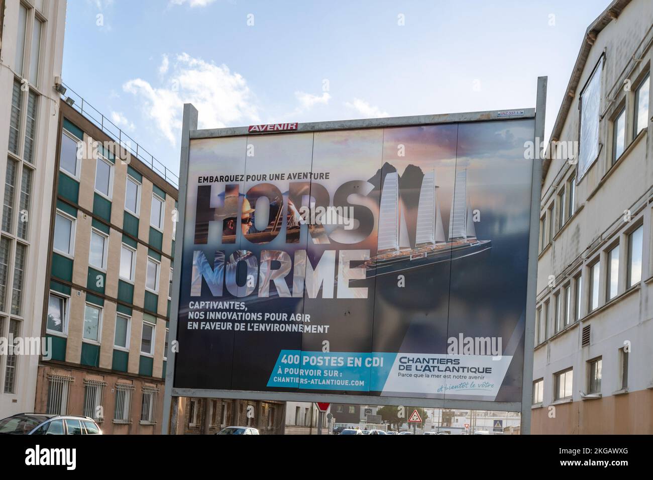 A sign at the entrance to the shipyards announces the search for more ...