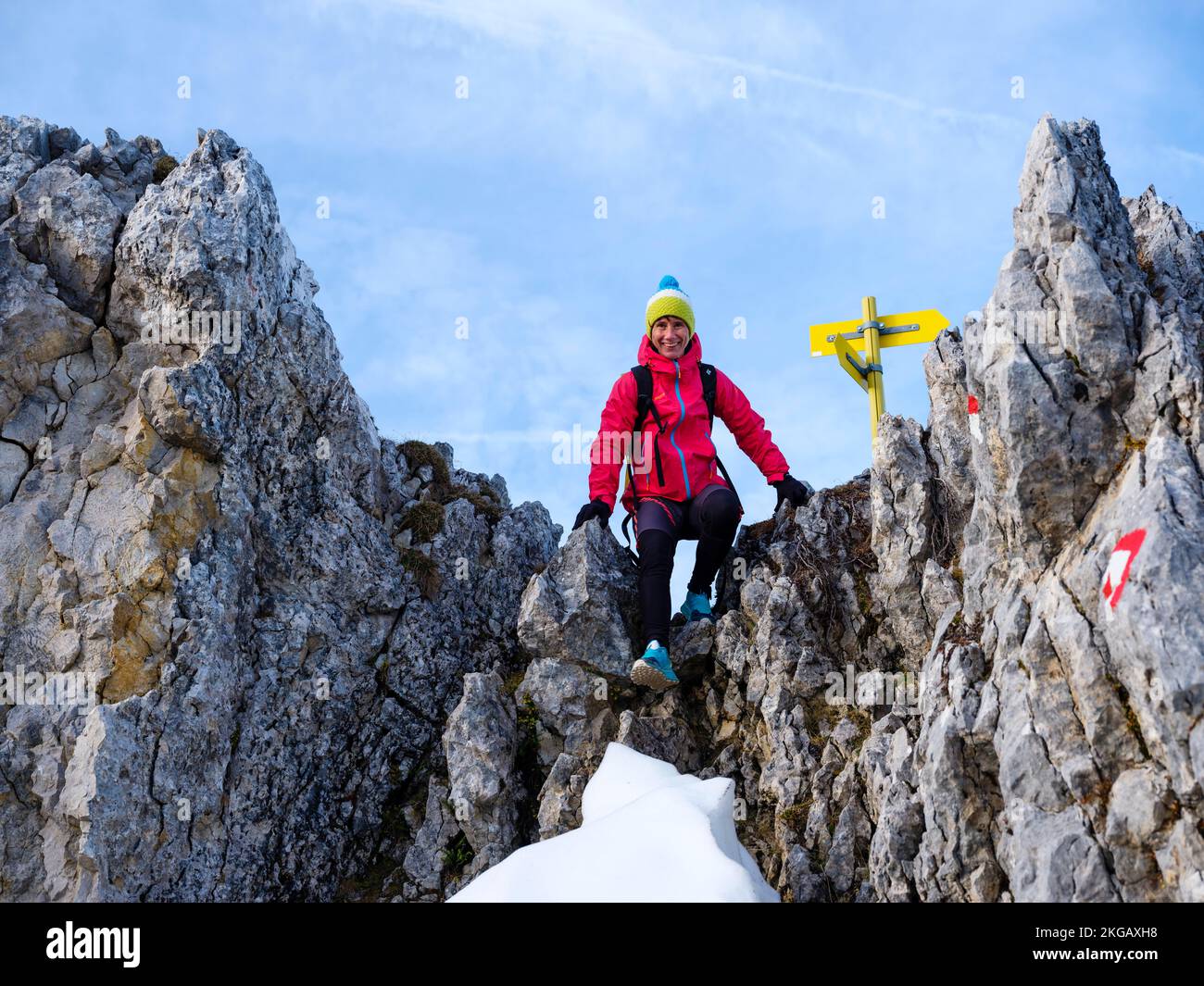 Mountaineer climbing over a rocky saddle, Hoher Göll, Berchtesgaden ...