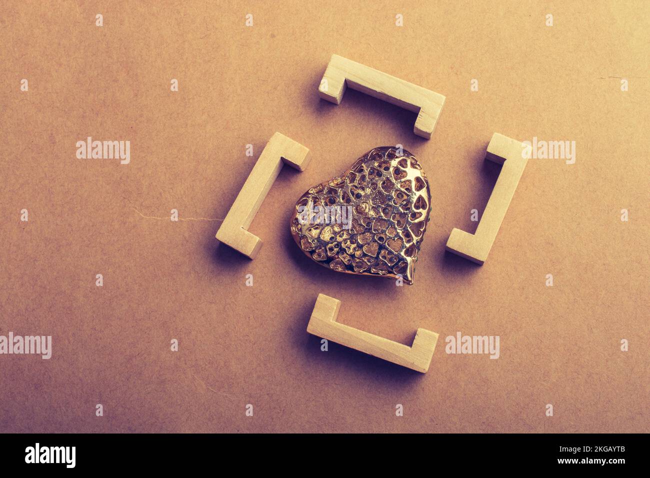 Gold color heart shaped decorative object in brackets in view Stock ...