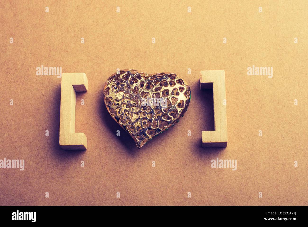 Gold color heart shaped decorative object in brackets in view Stock ...