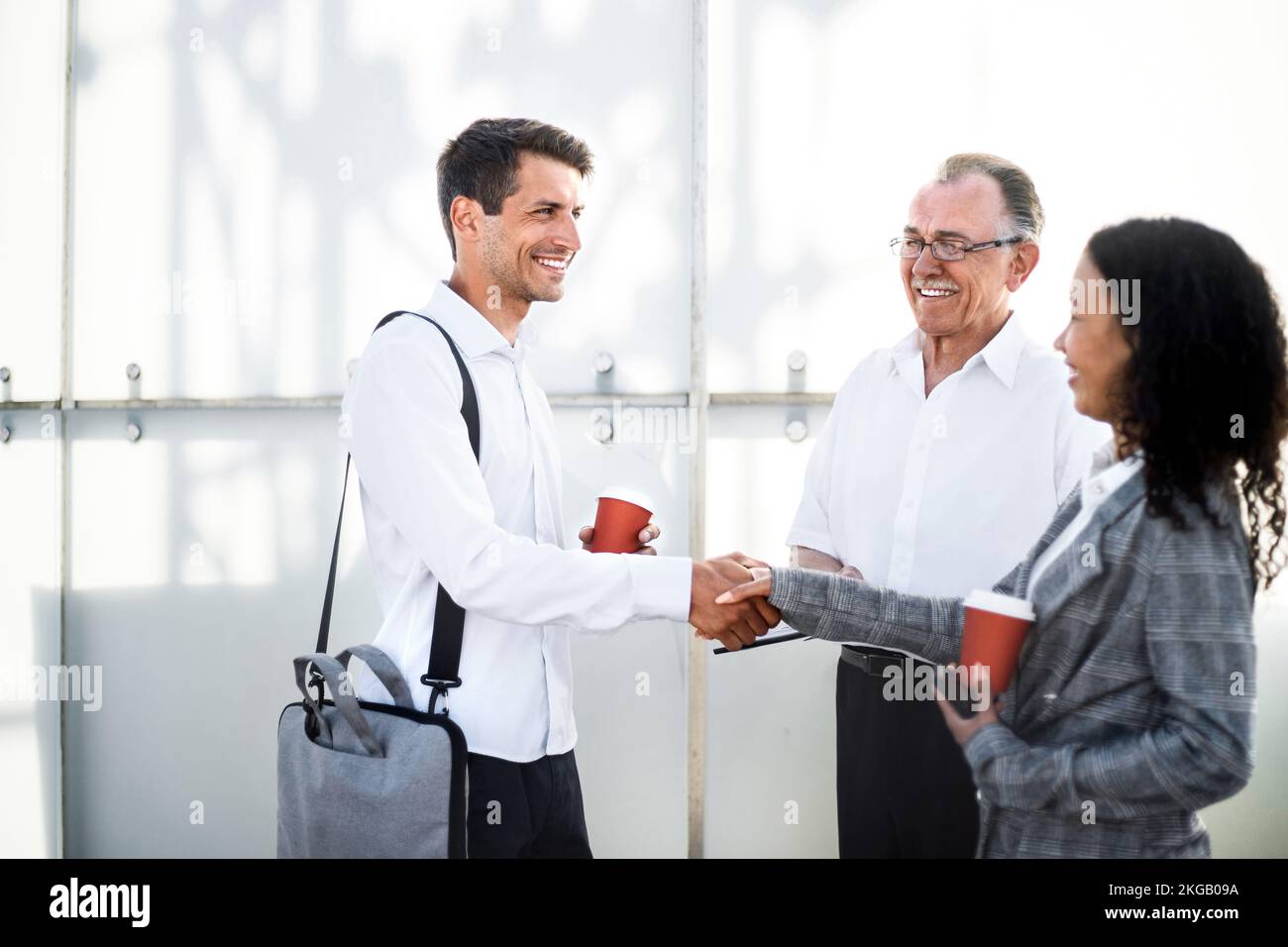 young entrepreneurs shaking hands at a chance meeting Stock Photo - Alamy