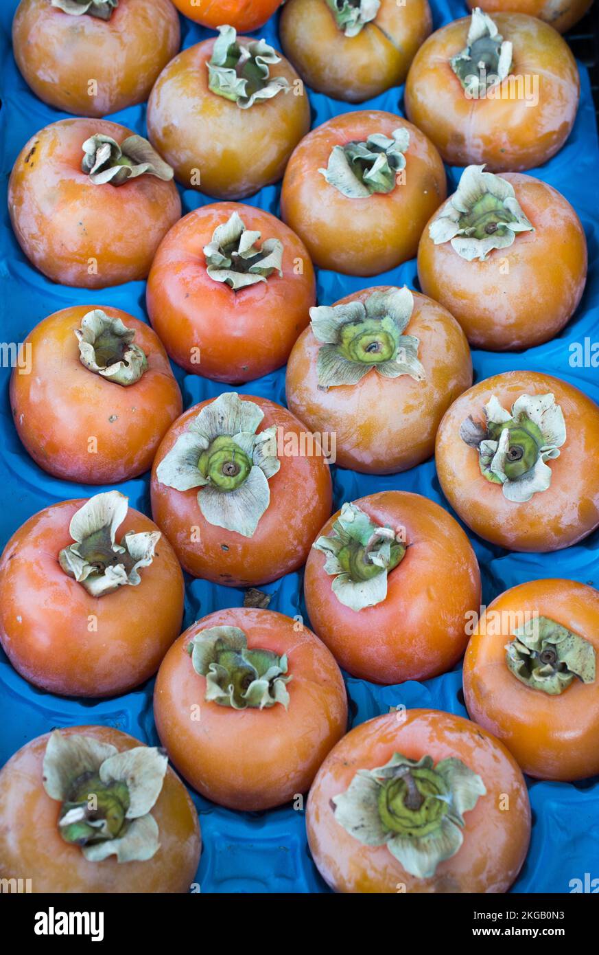 Persimmons in Turkish street bazaar in view Stock Photo - Alamy