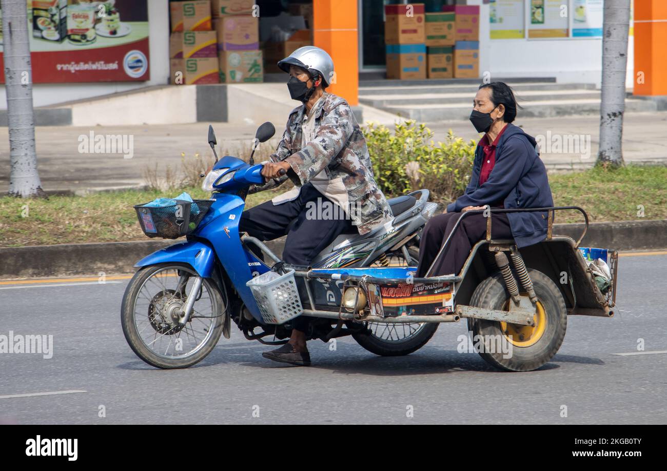 RATCHABURI, THAILAND, NOV 16 2022, A pair ride a motorcycle with a ...