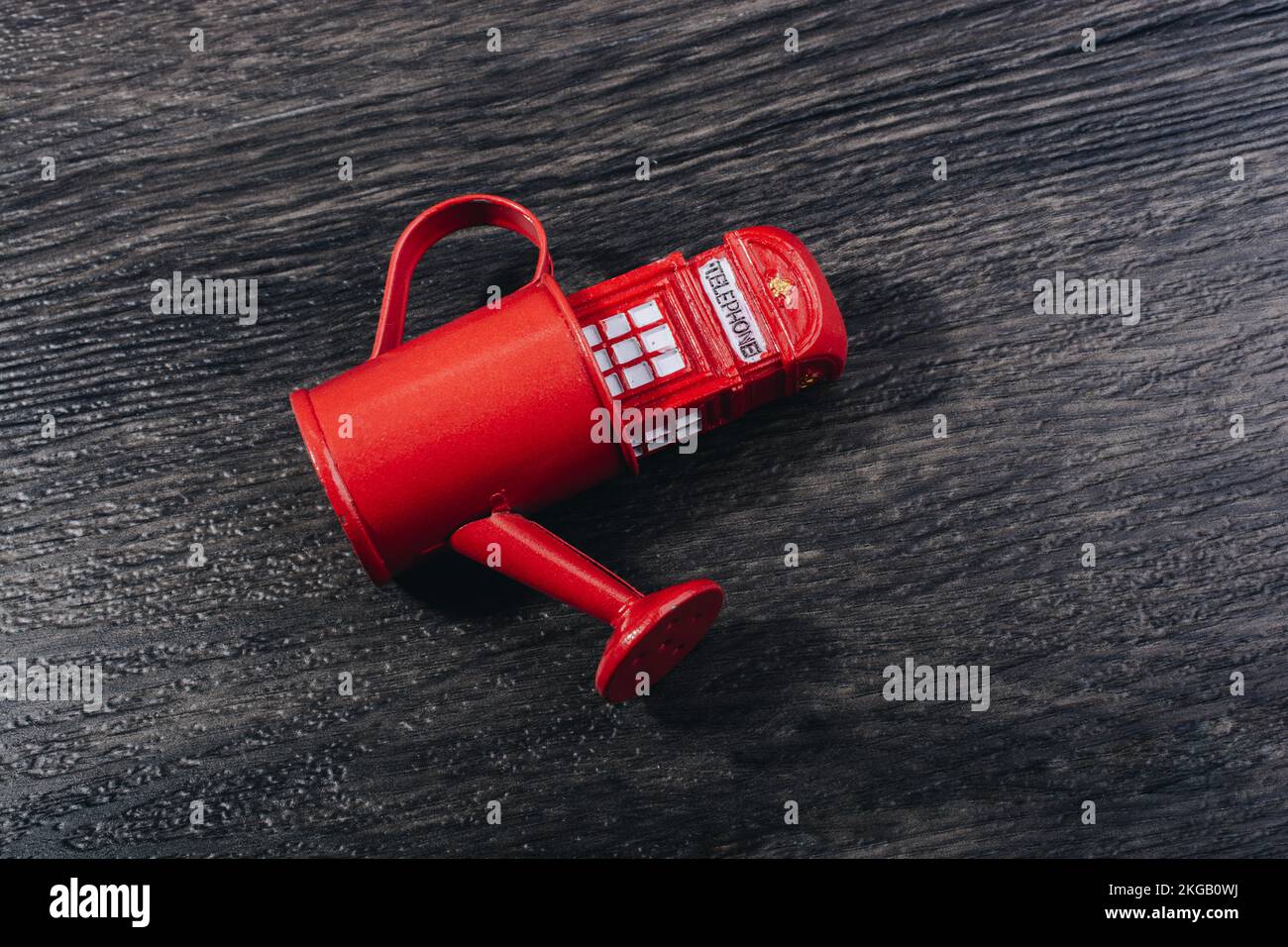 British style Red phone booth model in watering can Stock Photo - Alamy