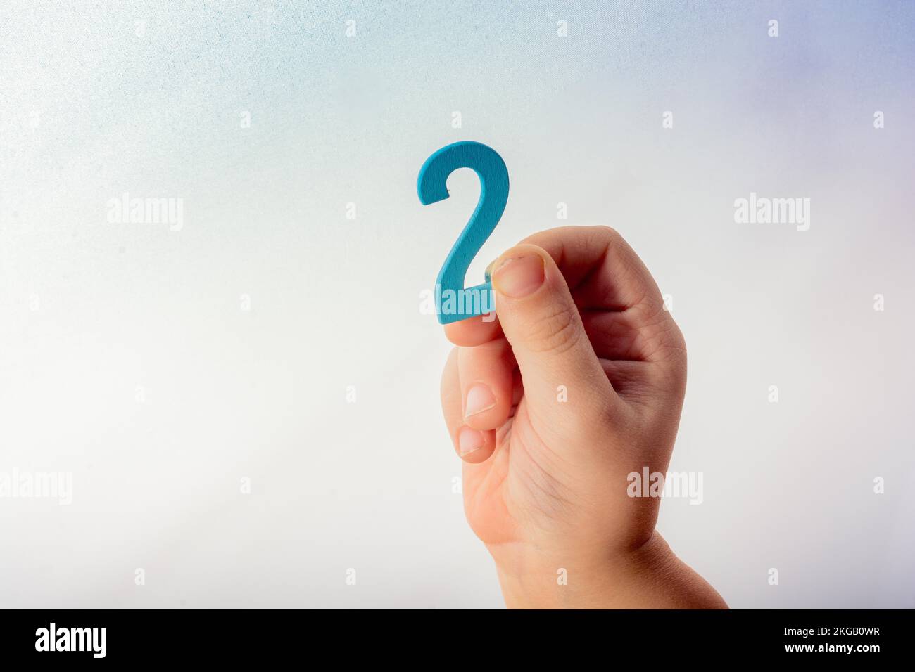 Number 2 two made of wood in the hand of a toddler Stock Photo - Alamy