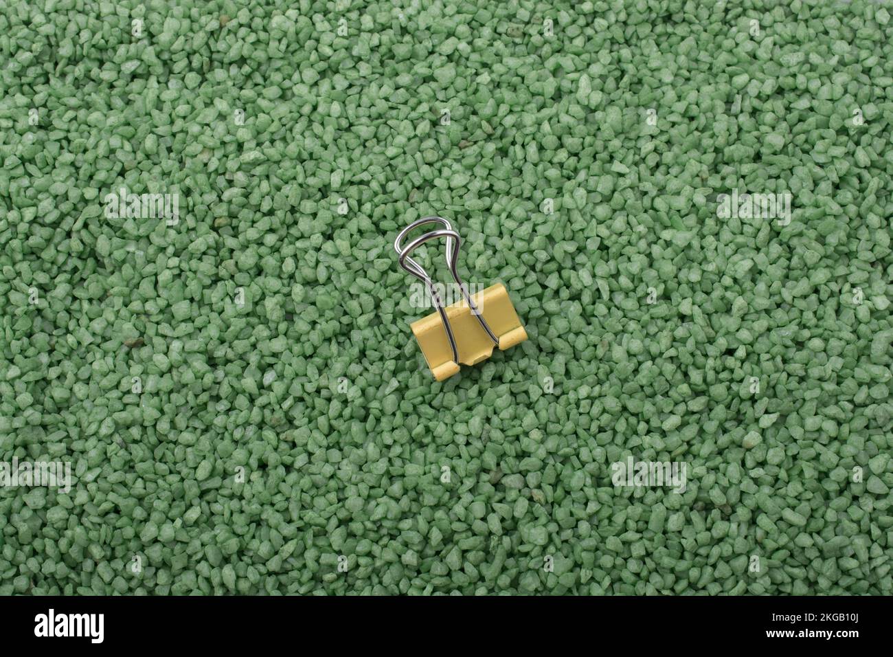 Colorful clip placed on some green sand Stock Photo - Alamy