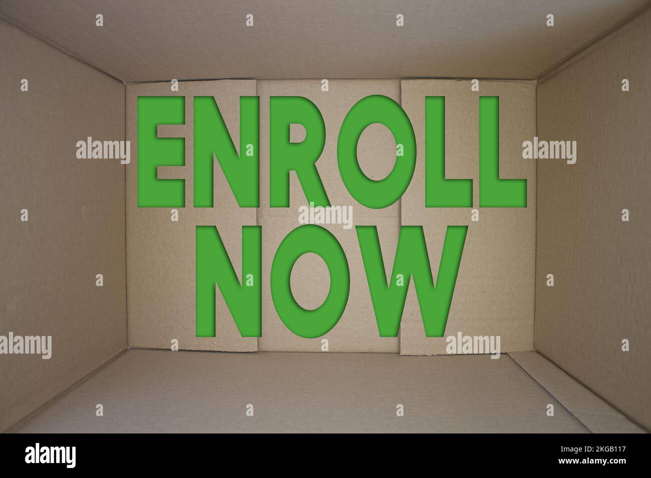 Enroll Now word with cardboard box. Brown folded card box Stock Photo ...