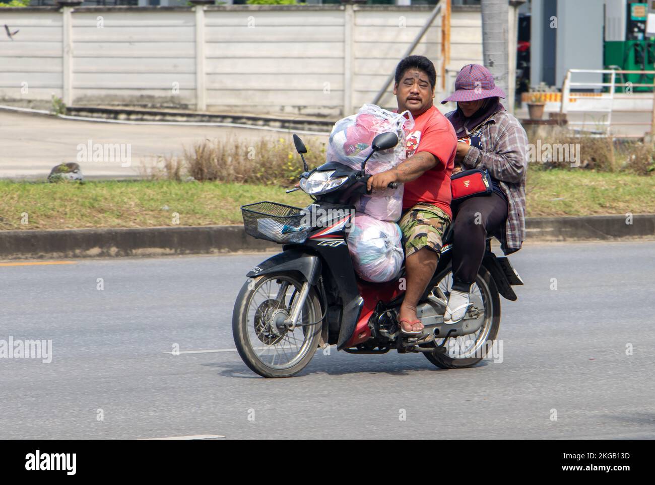 RATCHABURI, THAILAND, NOV 16 2022, A couple is riding a motorcycle with ...