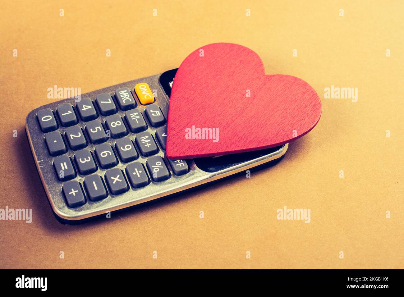 Heart shape and calculator with a keyboard and display Stock Photo - Alamy