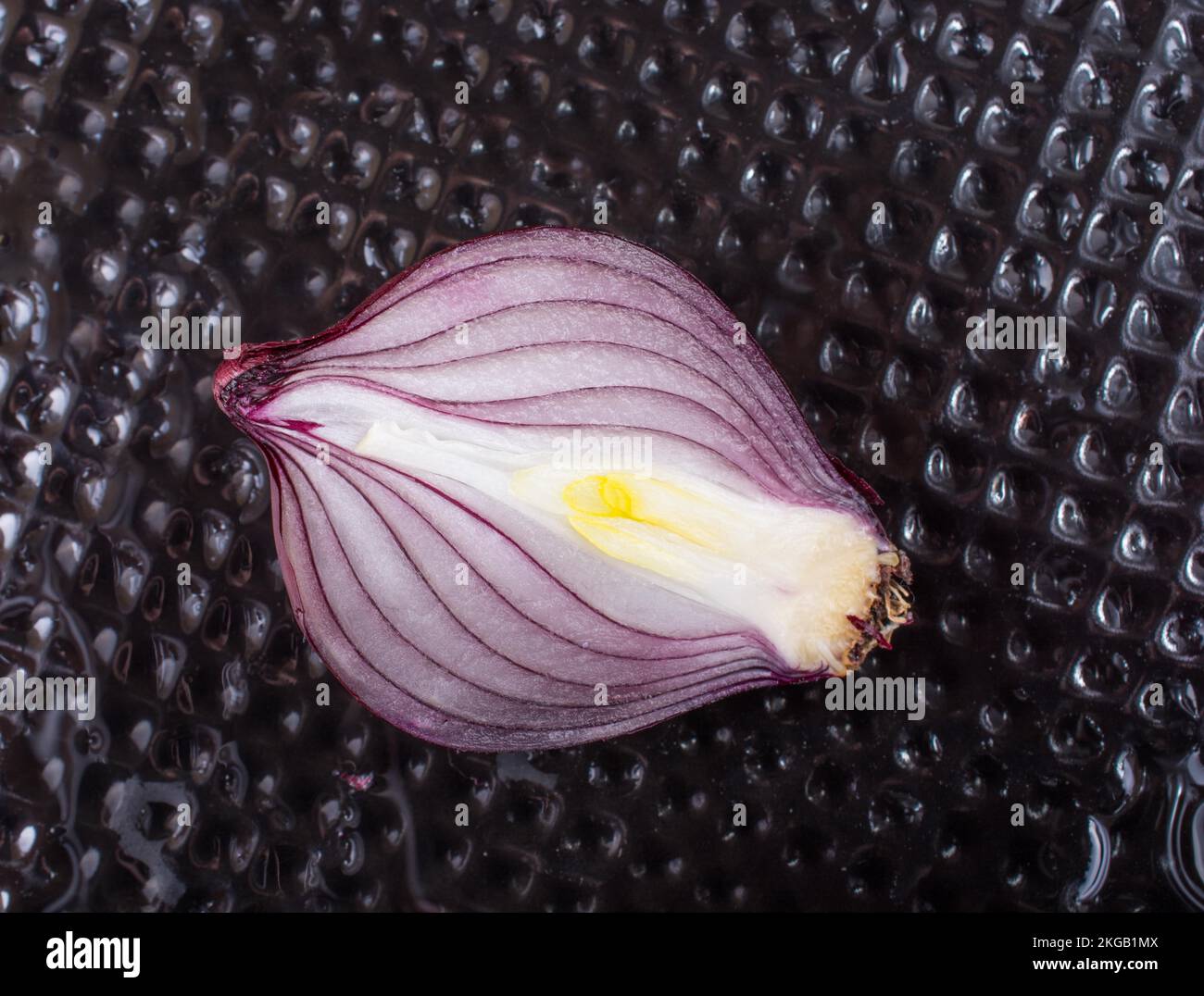 Red onion bulb cut in half on a certain background Stock Photo - Alamy