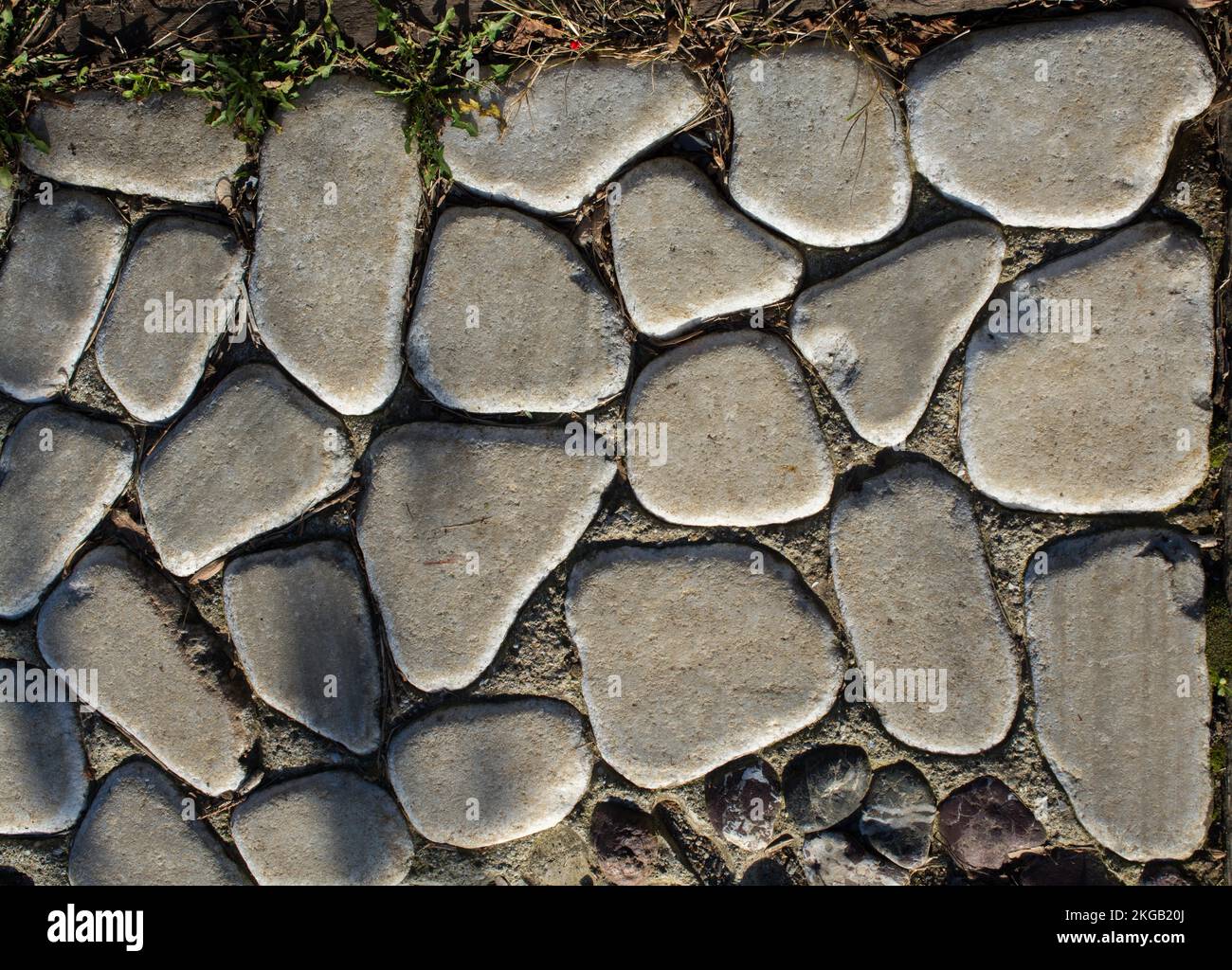 Wall surface consisting of round rocks in the view Stock Photo - Alamy