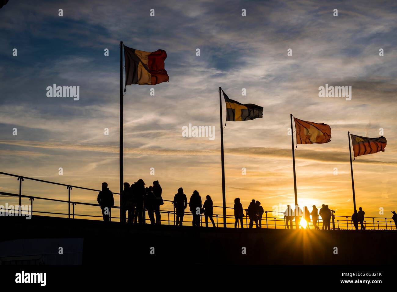 People, silhouettes, flags, harbour in Lindau am Lake Constance ...