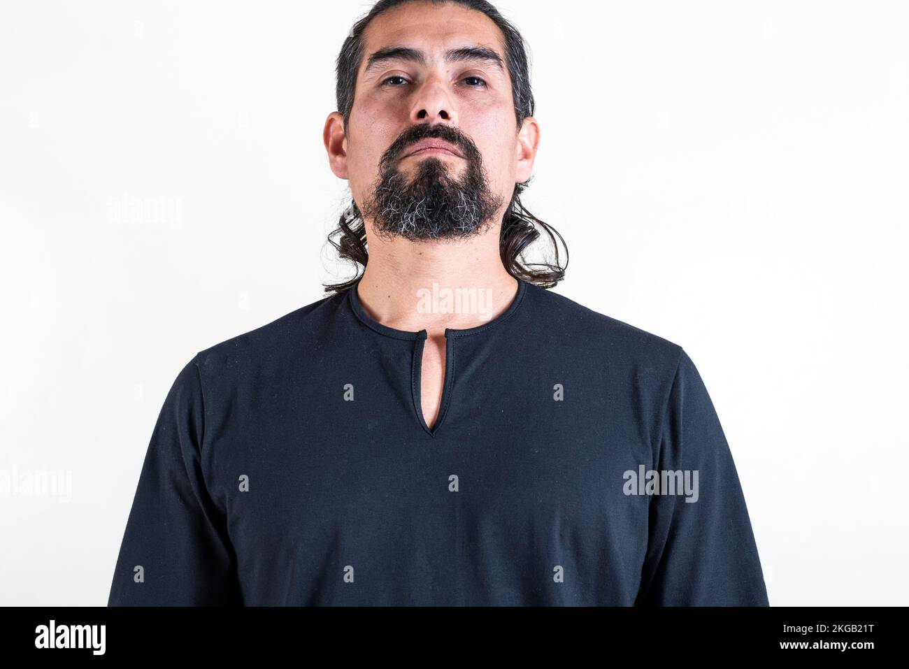 Latin handsome serious man looking at camera over white background ...
