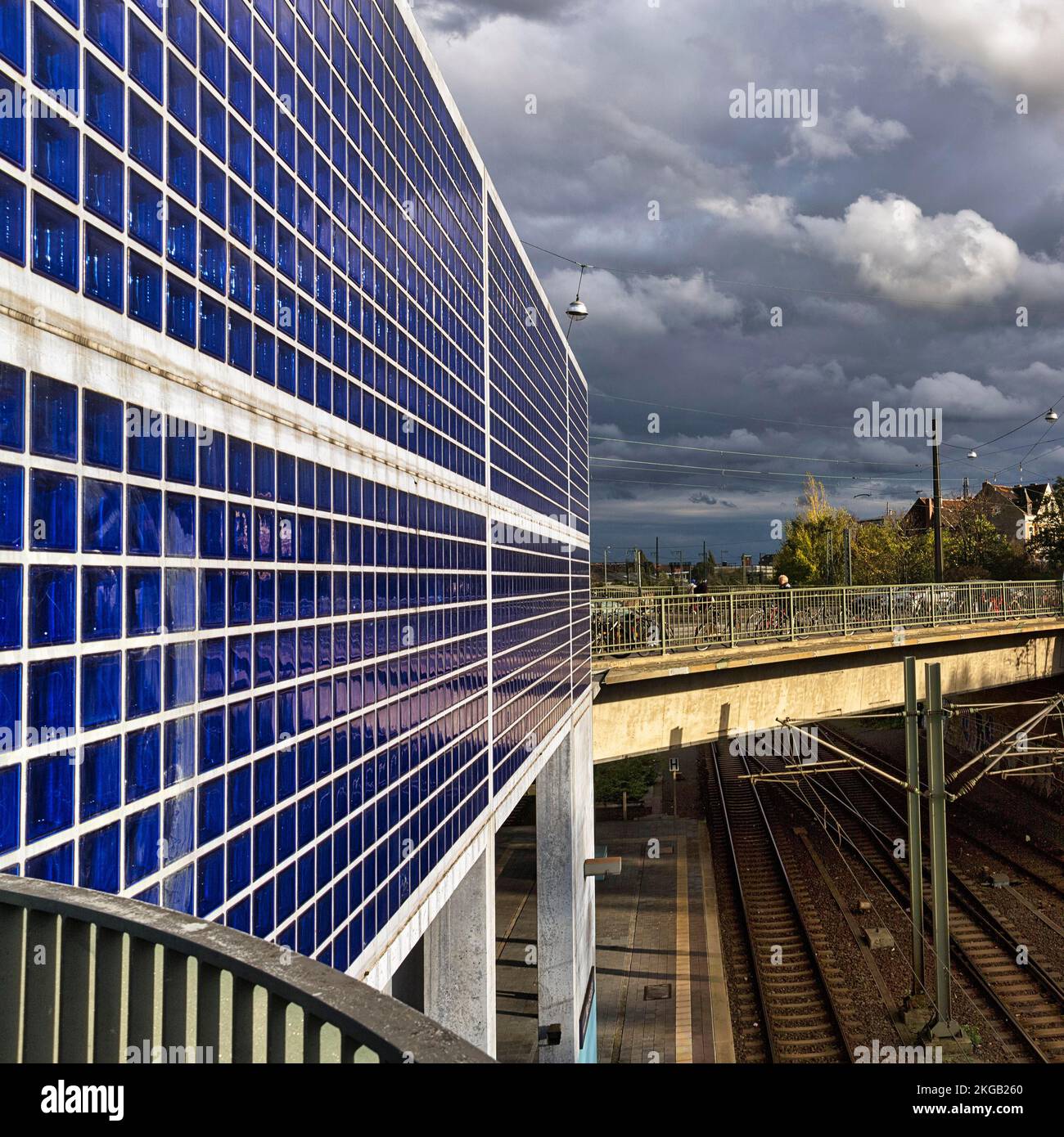 Station building made of blue glass blocks and exposed concrete ...