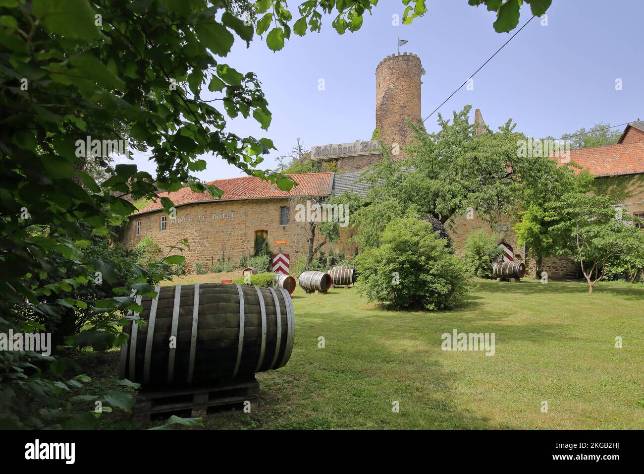 Courtyard and garden of Burg Layen Schlossgut Diel winery, wine barrels ...