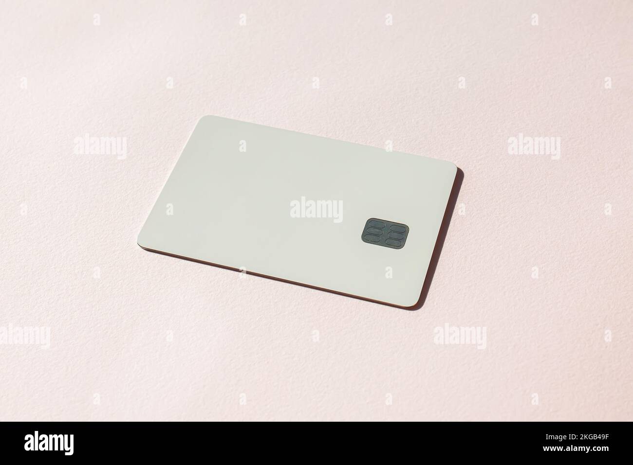 Photo of white credit or debit card with chip isolated on pink ...