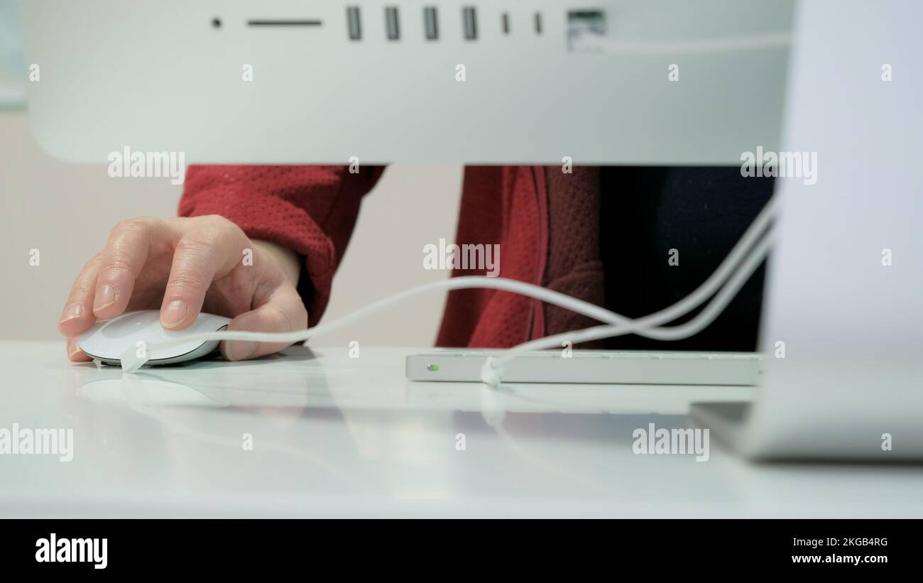 Woman works on big, white personal computer. Close up shot Stock Photo ...