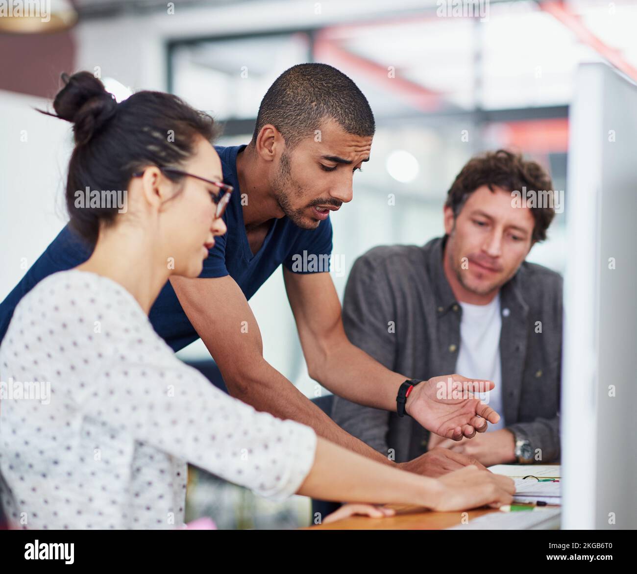 Creatives at work. a group of designers talking together while sitting ...