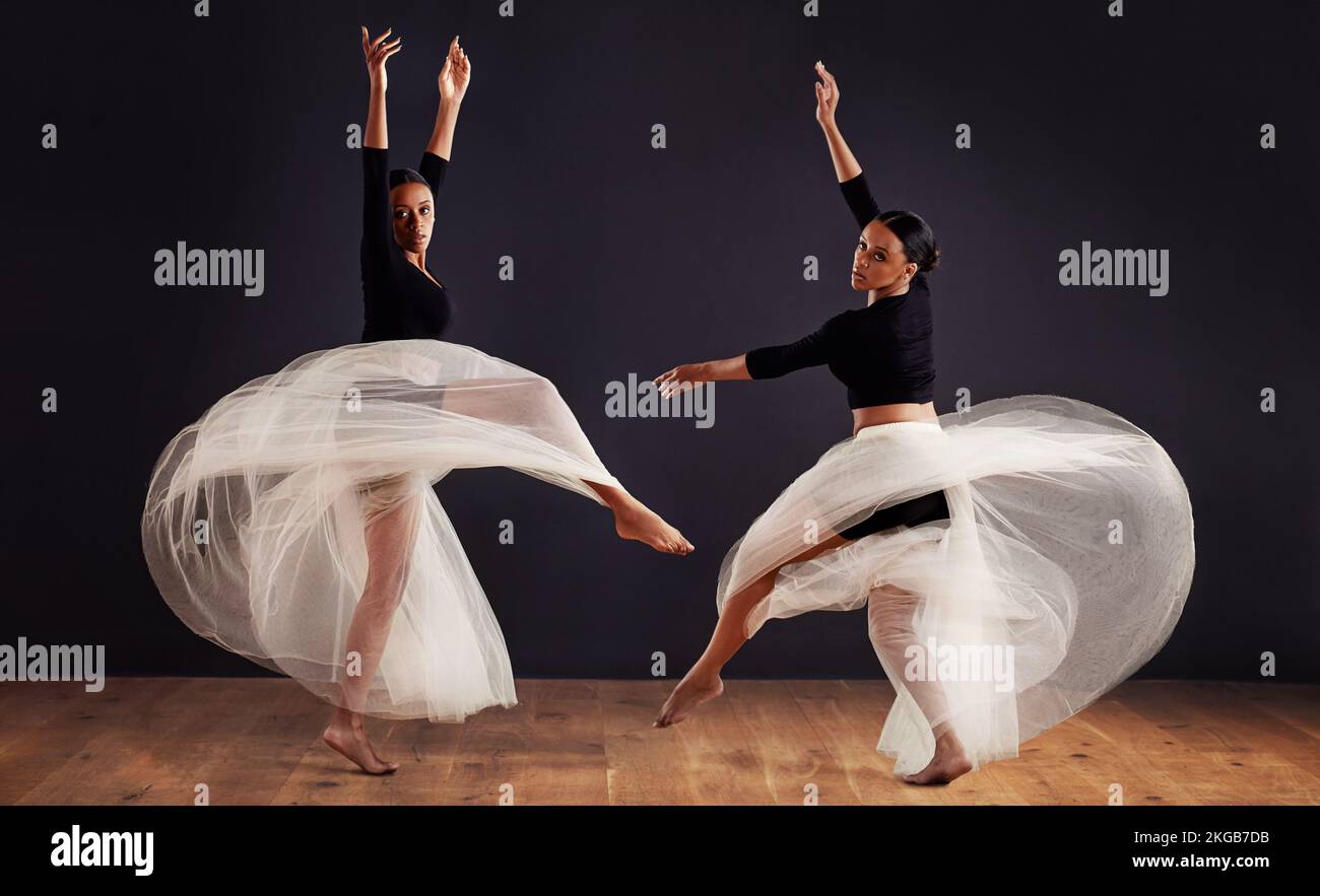 Dance of the wind. Two young female contemporary dancers using a soft ...