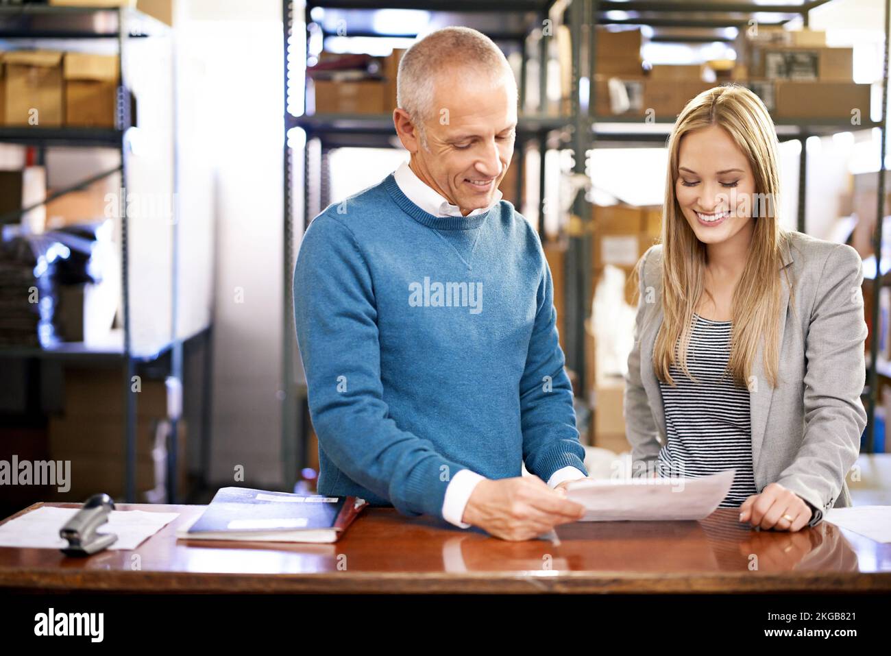 Weve moved a lot of orders today. a two managers looking through ...