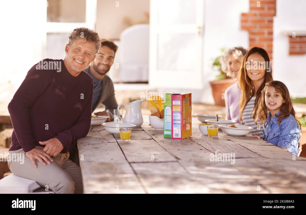 Food tastes better when you eat it with family. Portrait of a family ...