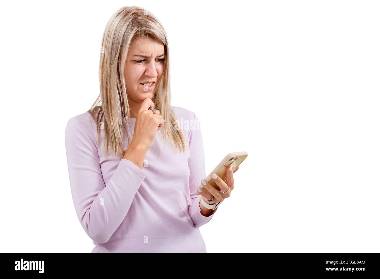 Girl looks into the phone with embarrassment isolated on white ...