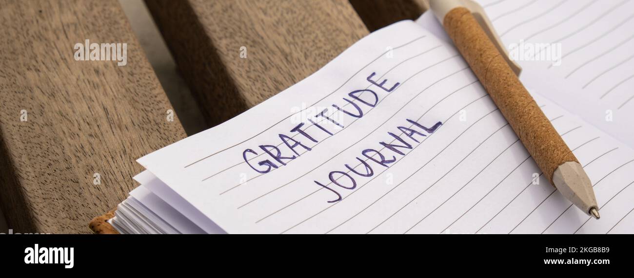 Writing Gratitude Journal on wooden bench. Today I am grateful for ...