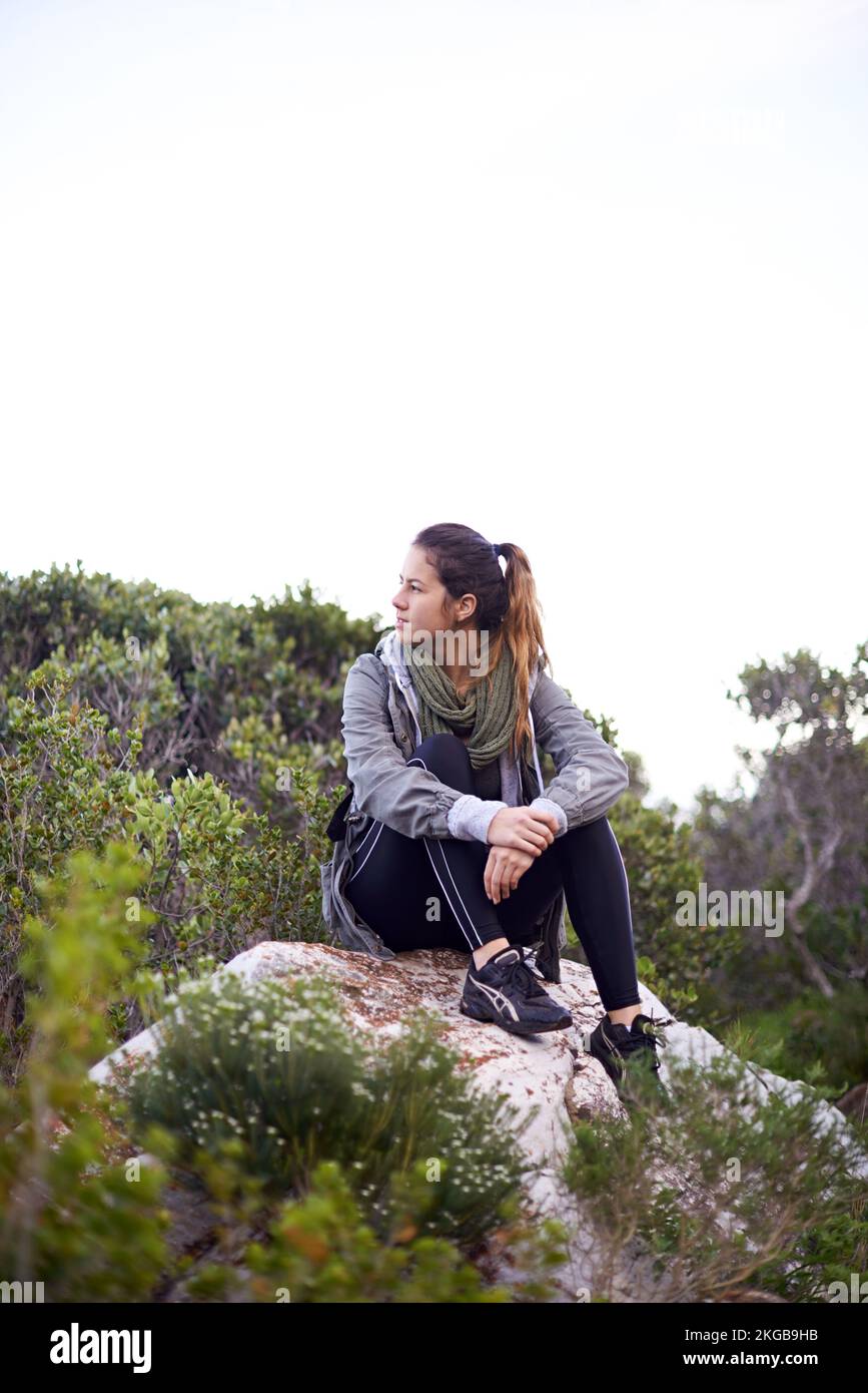 This is perfect. an attractive young woman taking a break while out ...