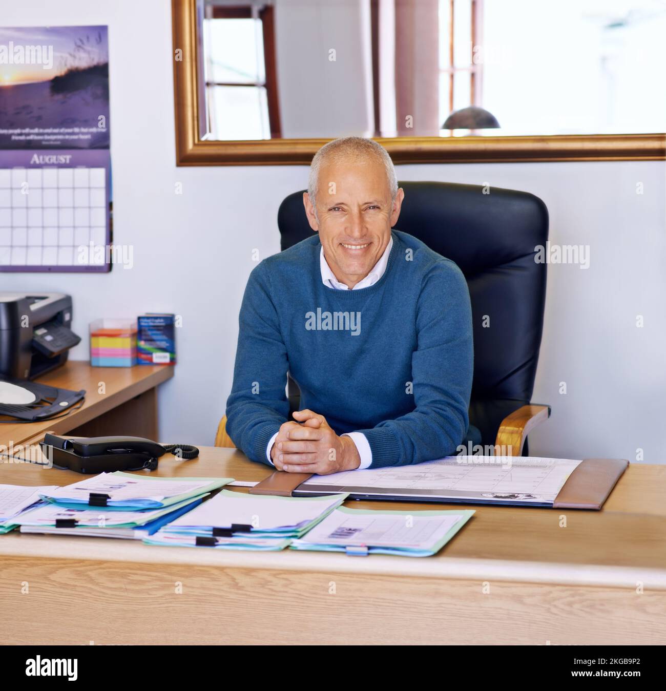Please, sit down. A cropped shot of a handsome businessman working at ...