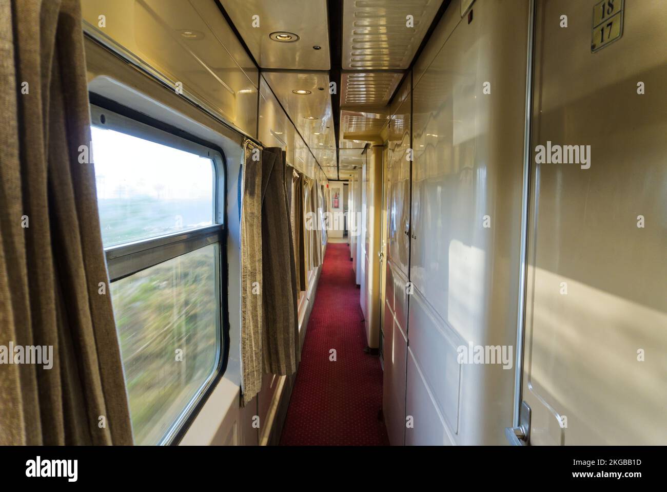 The inside of a train with a red carpet and rooms Stock Photo - Alamy