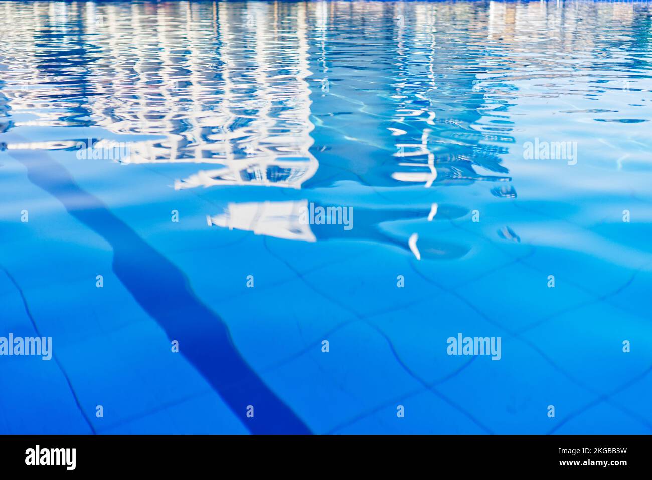 A top view of a checkered pool filled with water reflecting the ...
