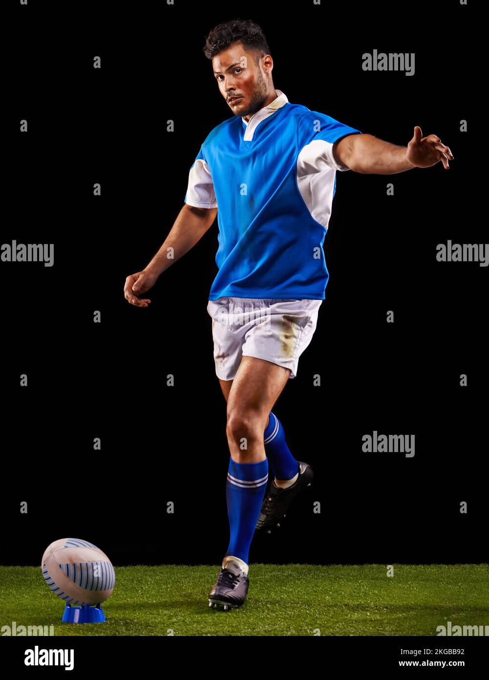 Going in for the kick. a young rugby player on the field Stock Photo ...