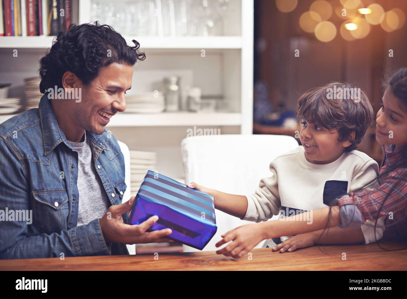 They got him the perfect Fathers Day gift...two children giving their ...