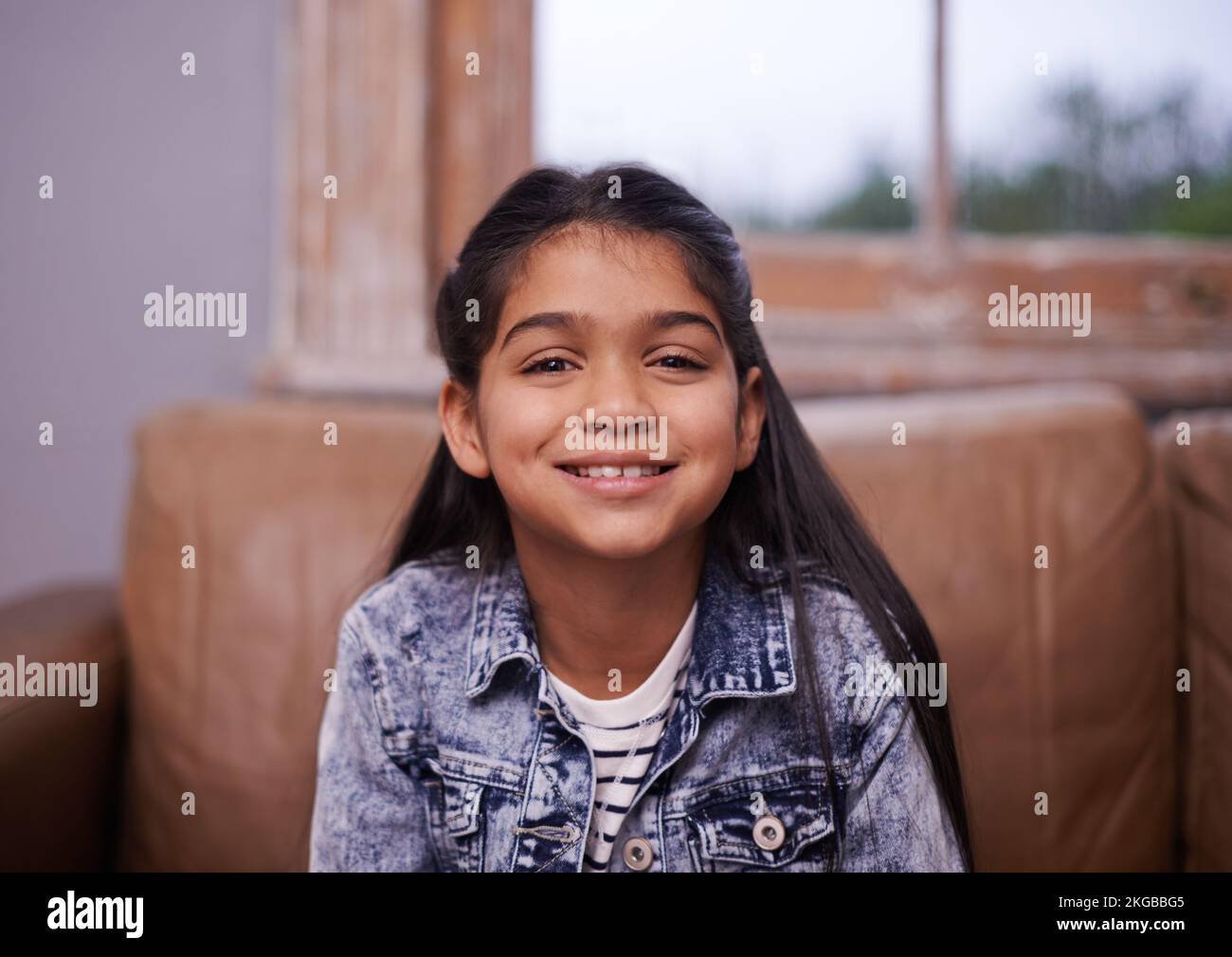 Such a sweet little girl. Portrait of a little girl on her sofa at home ...