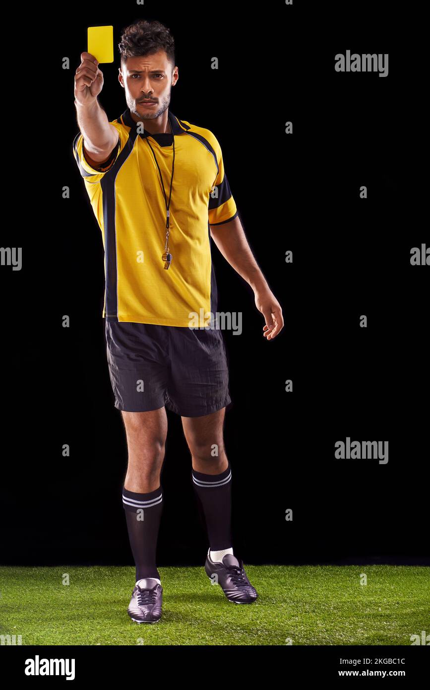 One more warning and youre off. a referee against a black background ...
