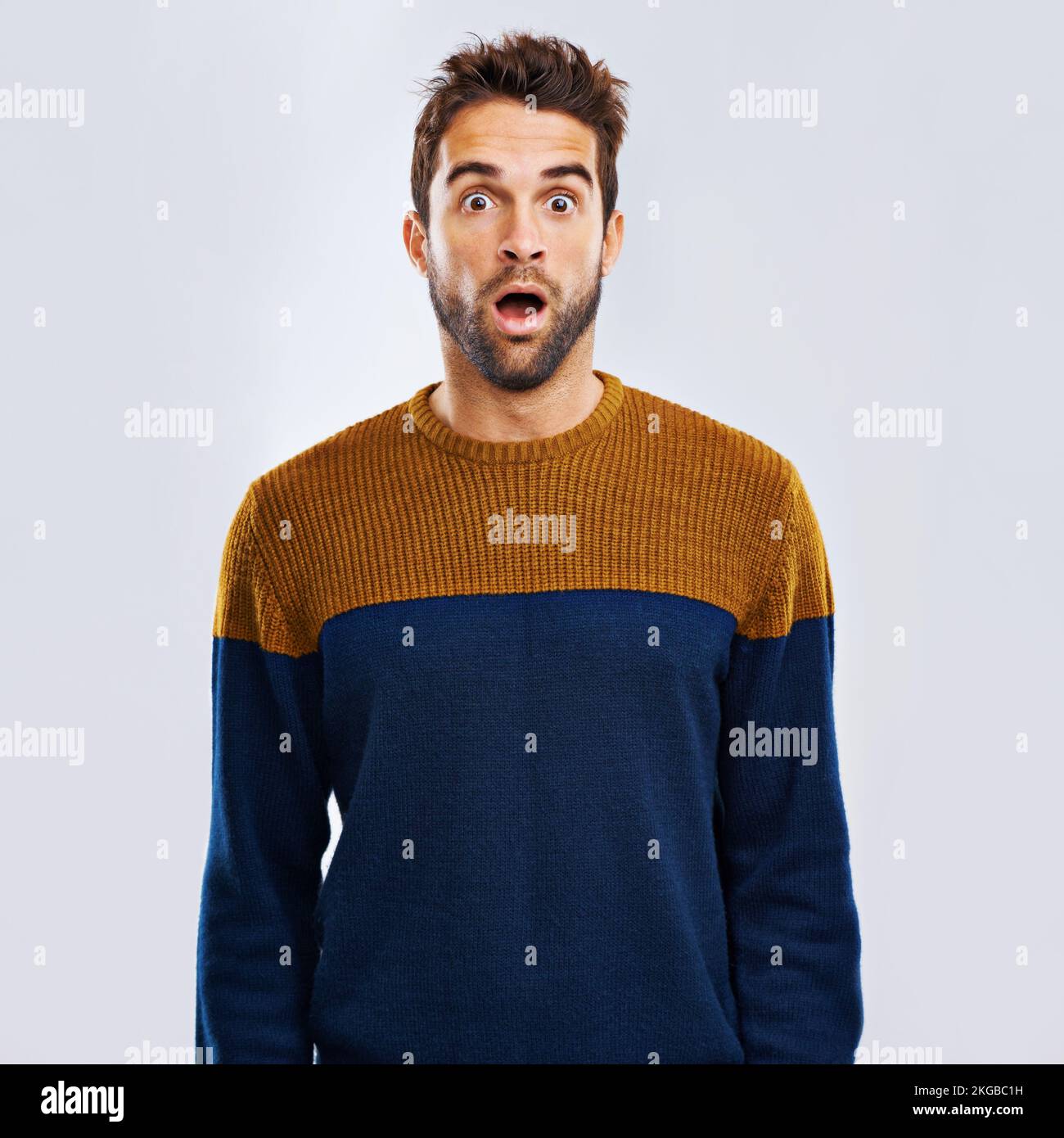 DIdnt see that coming. Portrait of a shocked young man against a gray ...