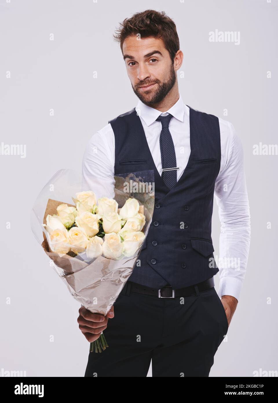 These are for you. Studio shot of a handsome and well-dressed young man ...