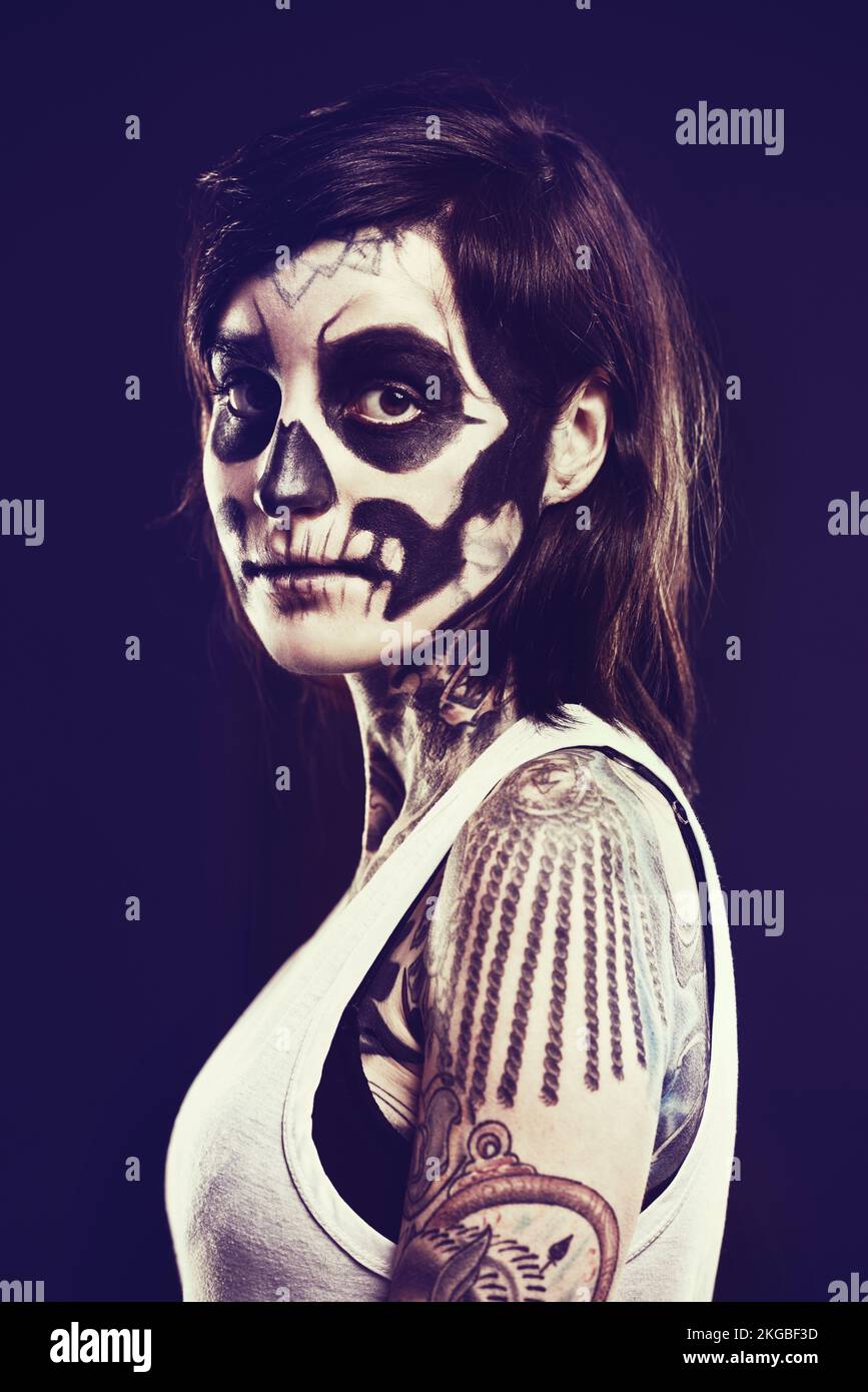 Facing death. A woman with a traditional calaveras death mask painted ...