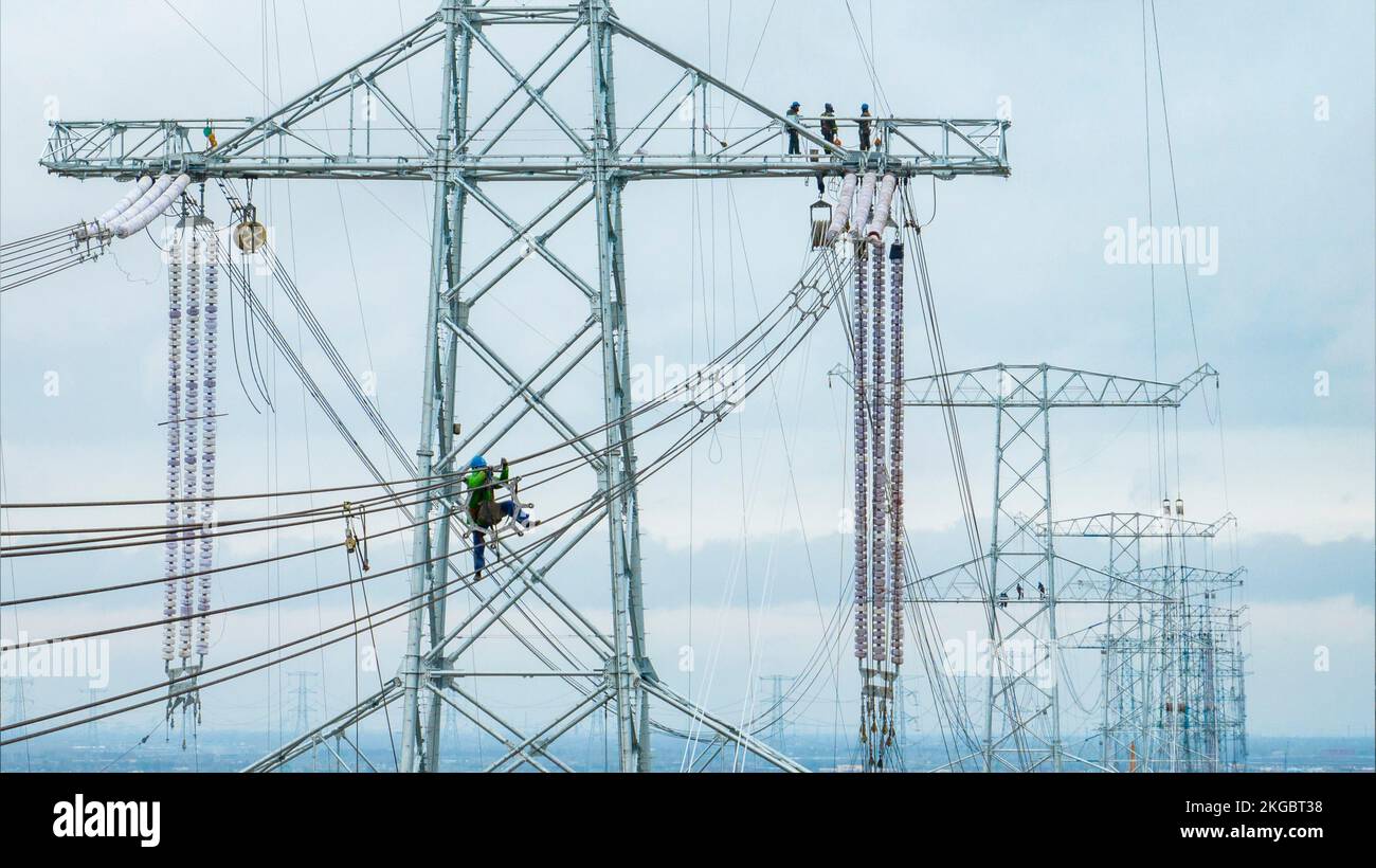 TAIZHOU, CHINA - NOVEMBER 23, 2022 - Construction workers erect a wire ...