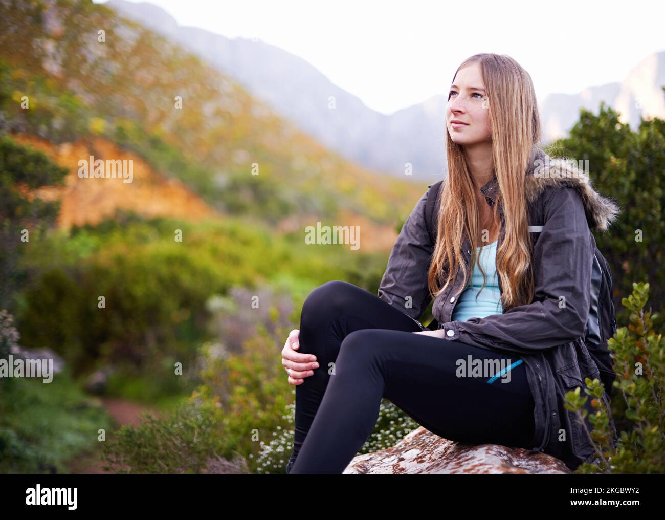 Just enjoying the view. an attractive young woman taking a break while ...