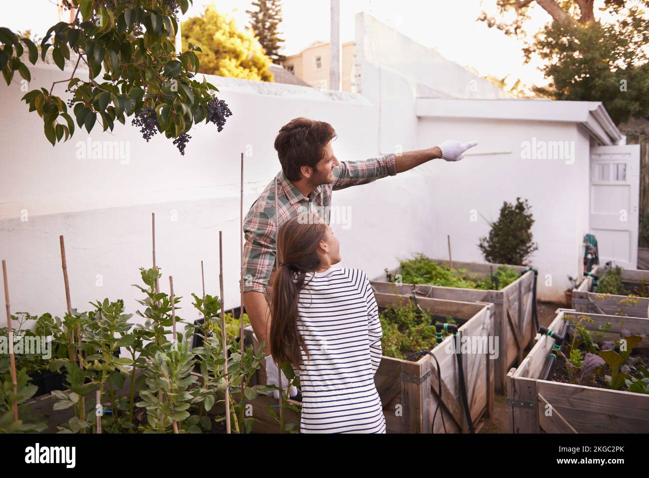 Gardening tips from dad. a father and daughter standing together in ...