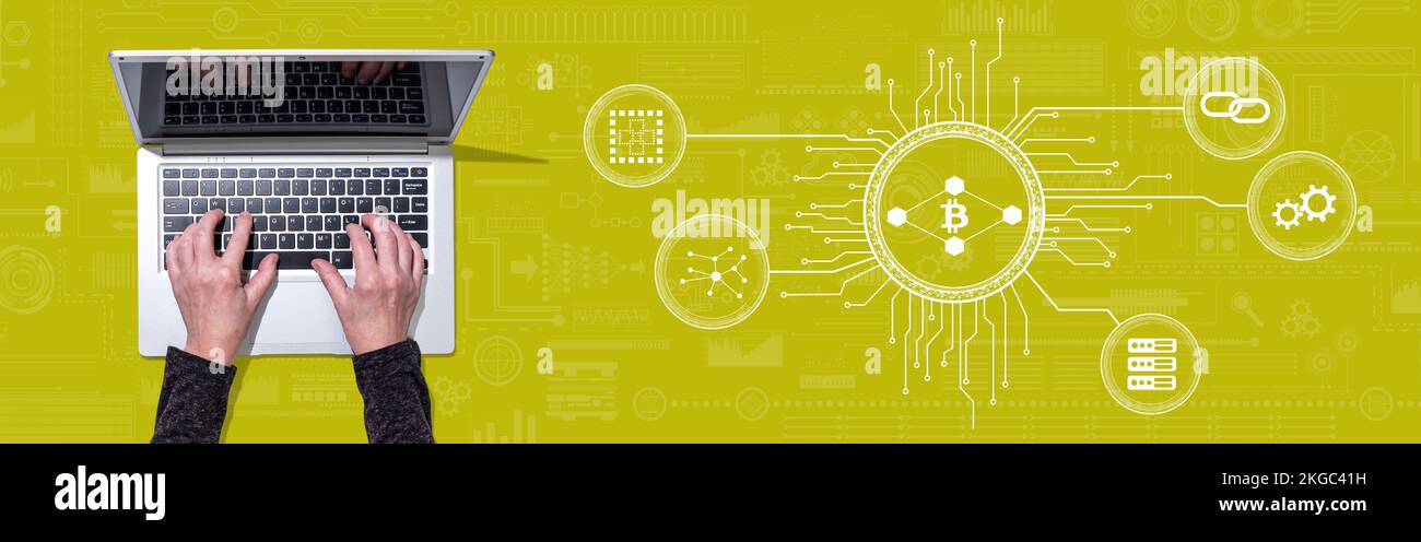 Top view of hands using laptop with symbol of blockchain technology ...