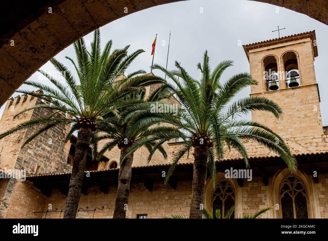 A low angle shot of a tower with a cross in Almudaina Palace, Mallorca ...
