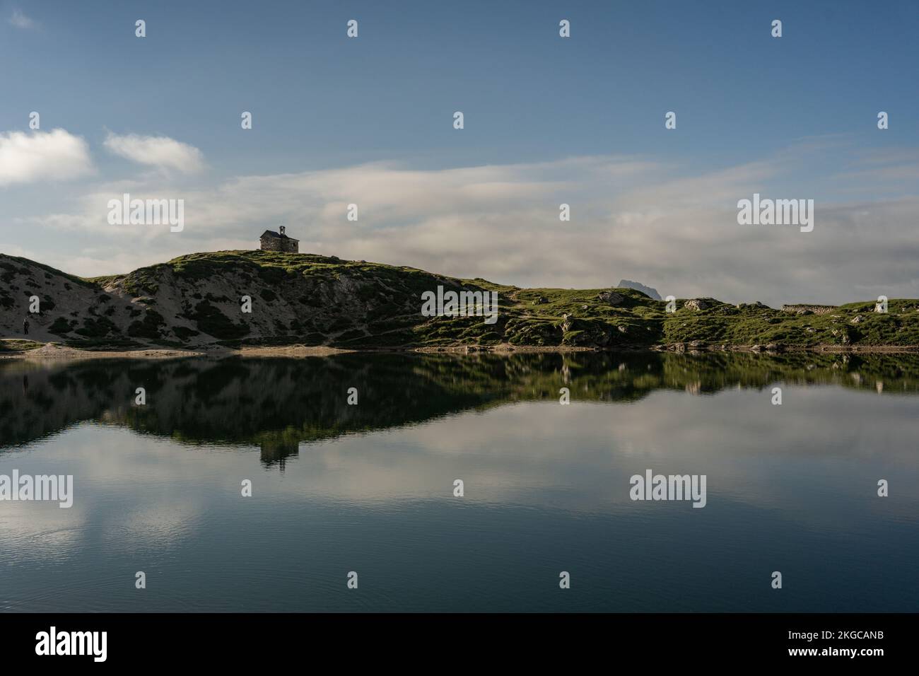 A scenic shot of the Oble lake in Italy with the mounts reflection on ...