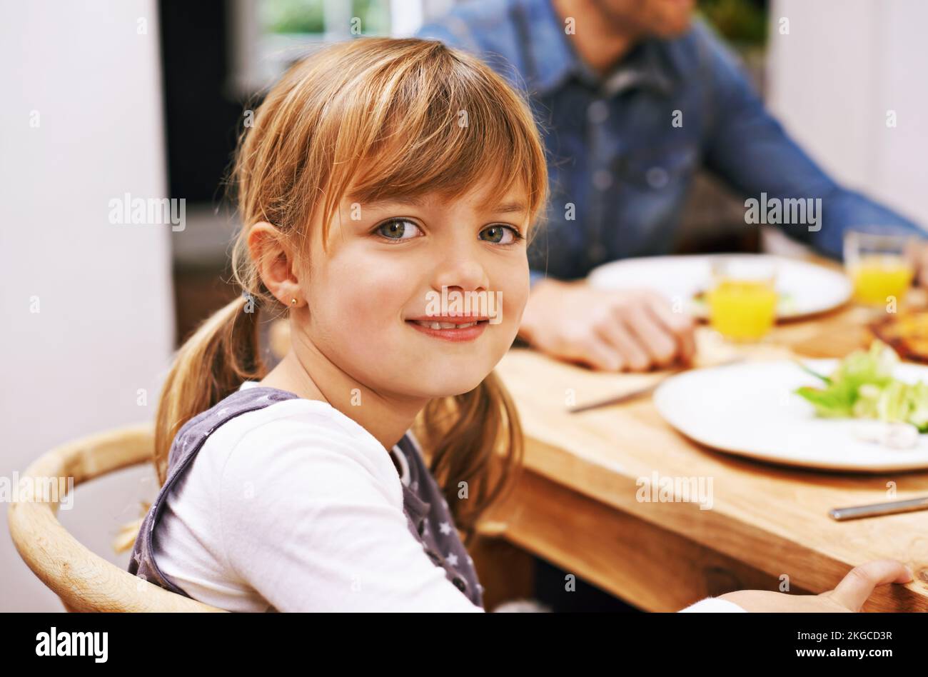 Family dinner is my favorite time of the day. A little girl sitting at ...