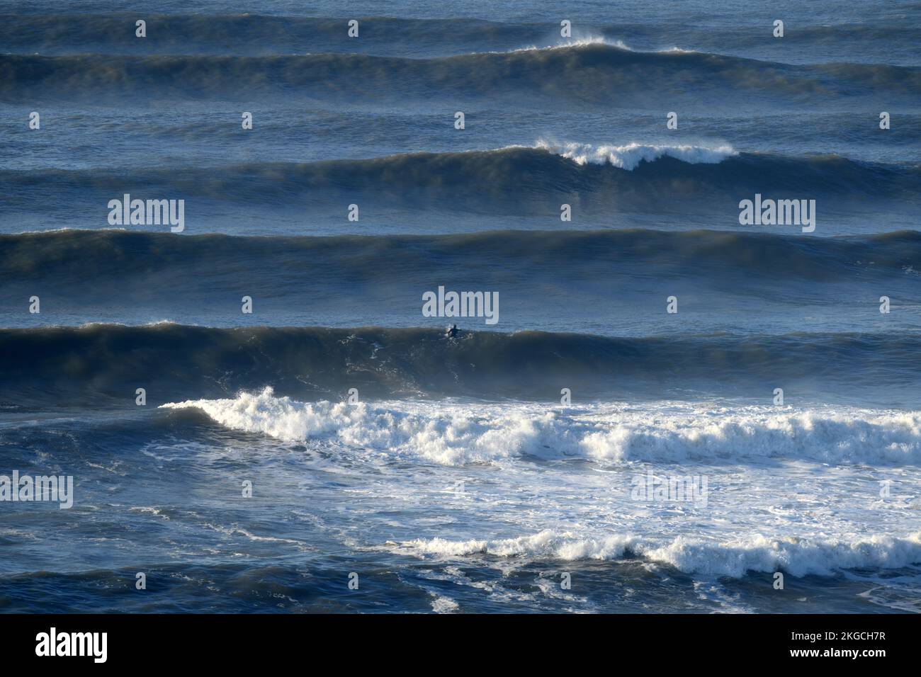 As winter approaches the UK shores a lone surfer braves the waves ...